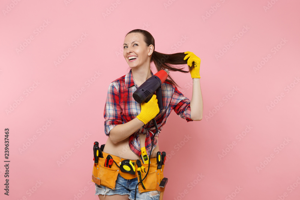 Young beautiful fun handyman woman in plaid shirt, denim shorts, kit ...