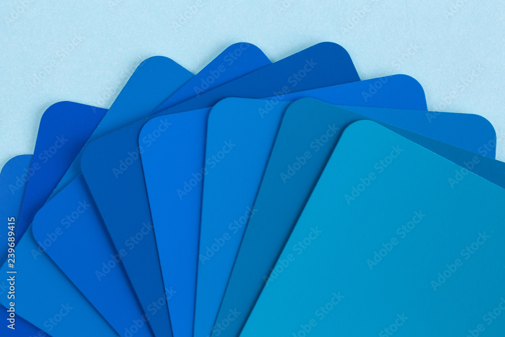 Color swatches sample cards in fan shape closeup - hues of blue with ...