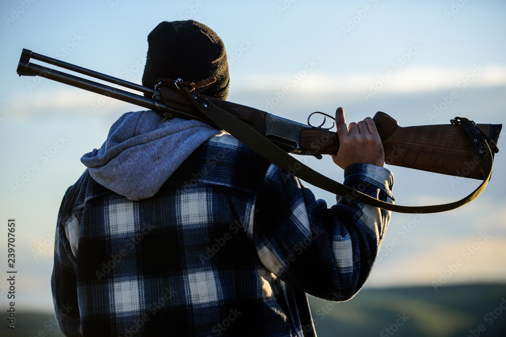 Hunter carry rifle gun on shoulder rear view. Guy hunter spend leisure ...