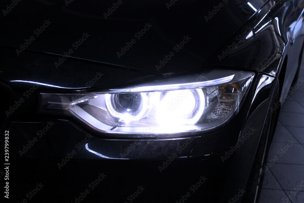 Headlight detail of modern automobile with auto projector lens. Front ...