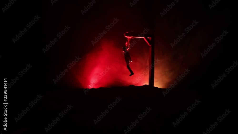Horror view silhouette of hanged man on scaffold at night with fog and ...