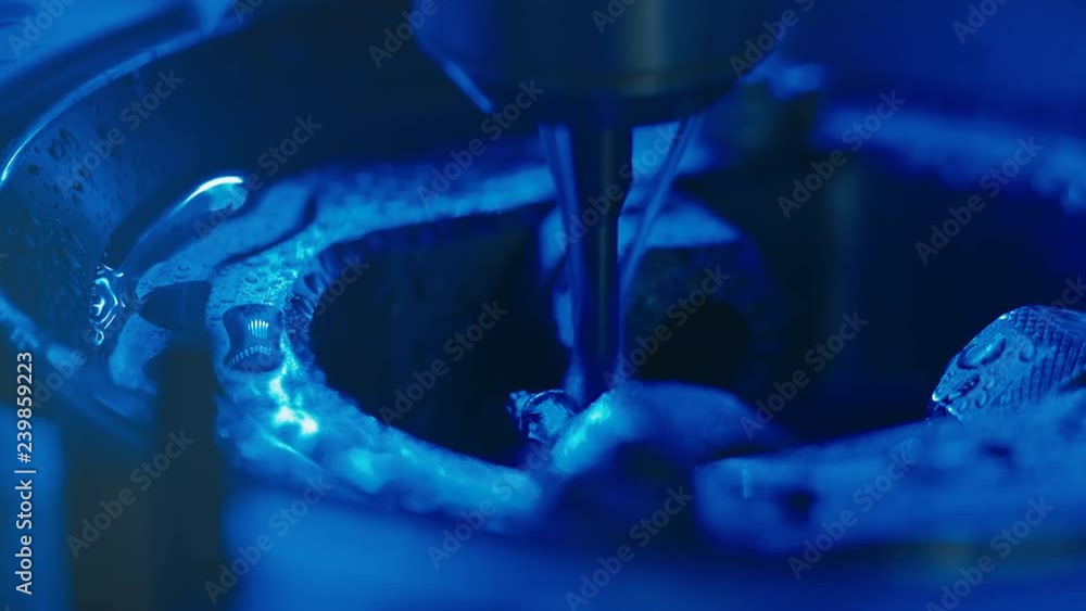 Dental milling machine carving out shape of human teeth from metal ...