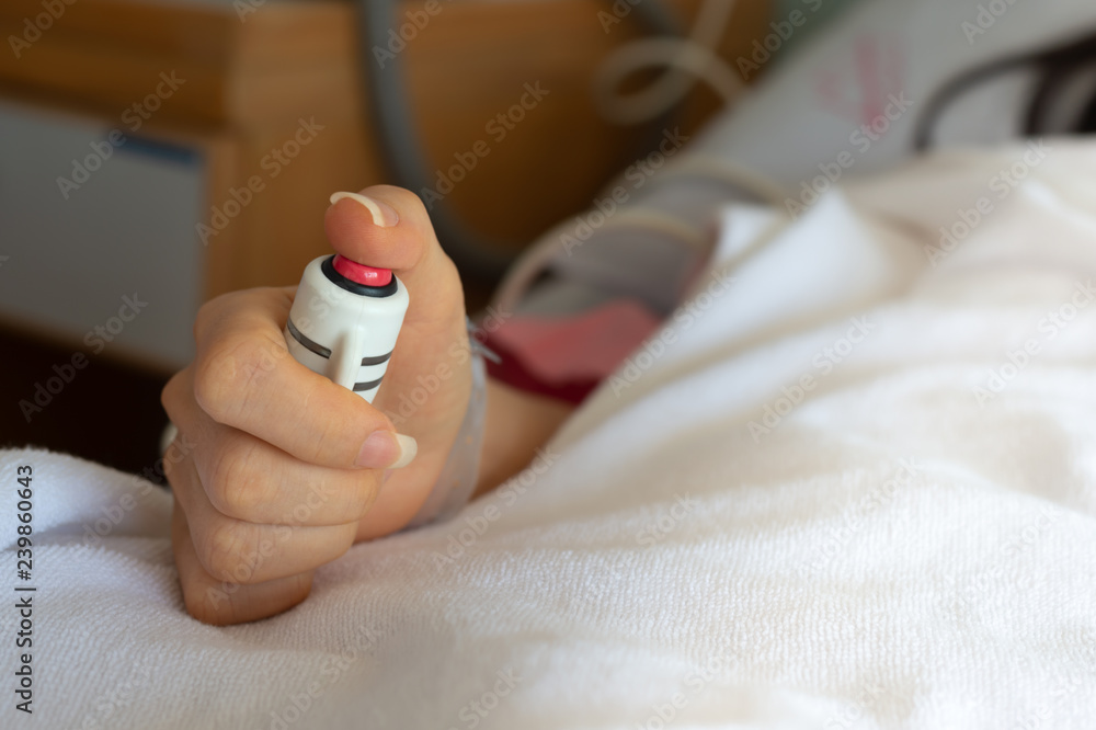Hand holding nurse call button,selective focused..Woman patient in ...