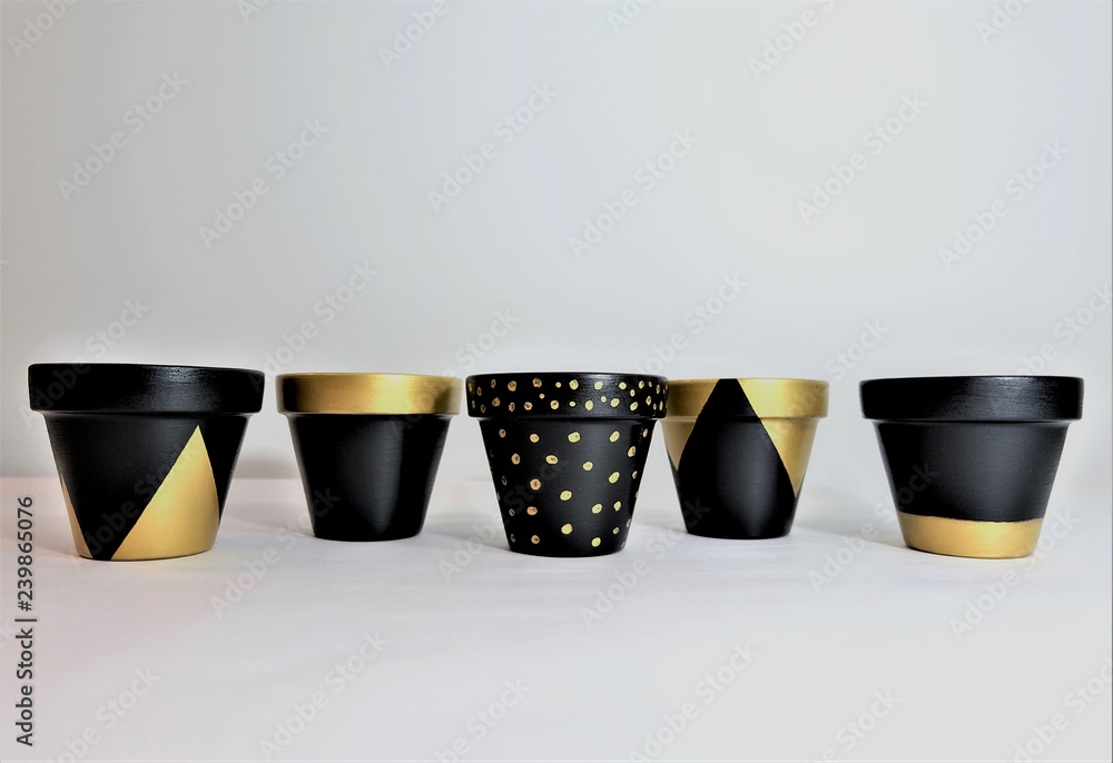 Set of five hand-painted ceramic pots using acrylic paint. Black ...