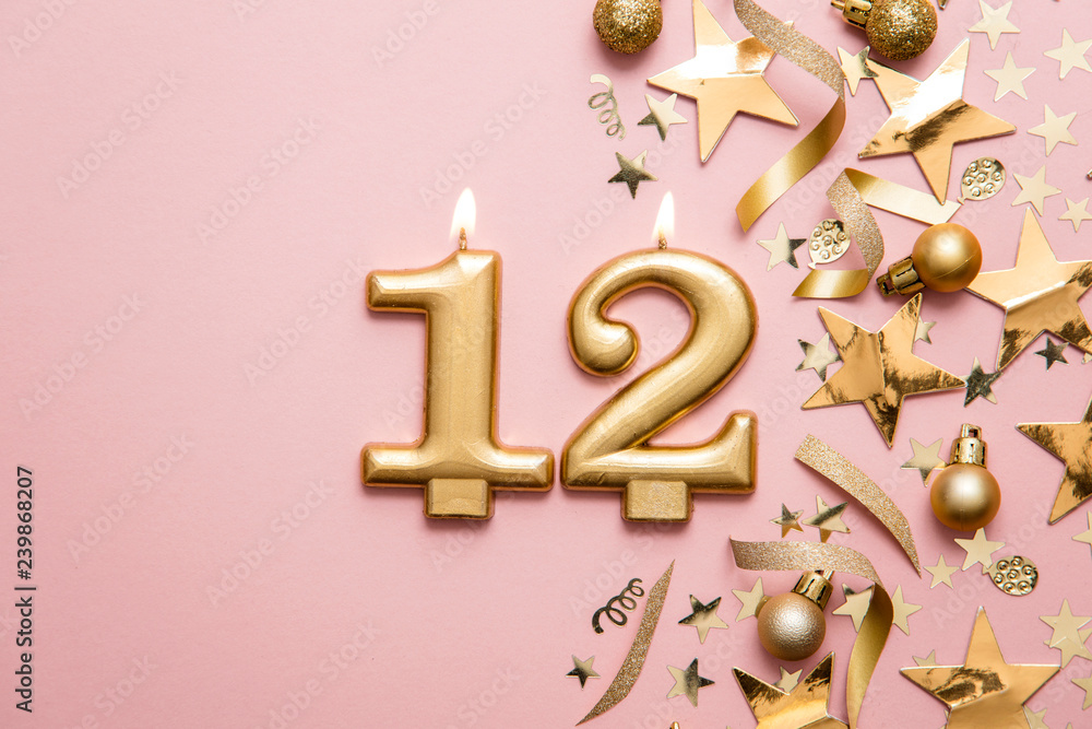 Number 12 gold celebration candle on star and glitter background Stock ...