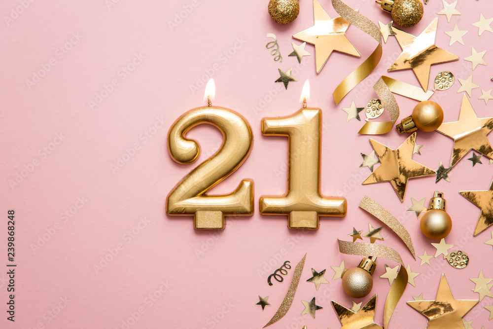 Number 21 gold celebration candle on star and glitter background Stock ...