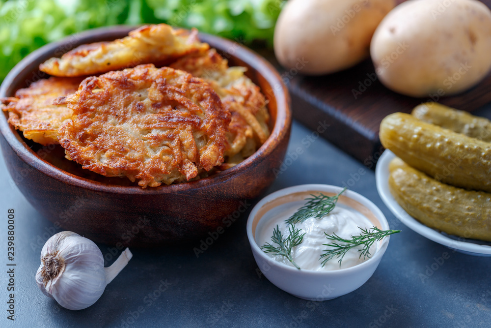 Draniki - potato fritters. potato pancakes lie on a plate. The national ...