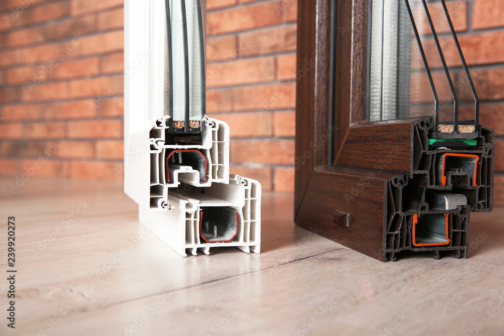 Samples of modern window profiles on floor against brick wall ...