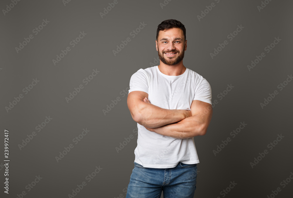 Muscular young man standing with his arms crossed Stock Photo | Adobe Stock