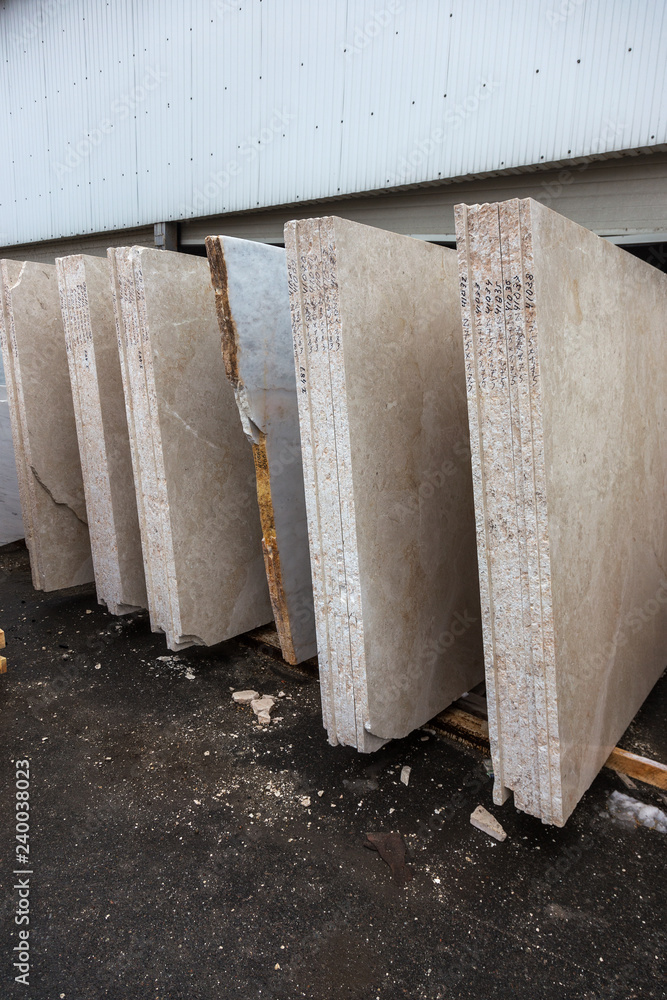 Side view of the edge of the granite slab in bulk. A stack of granite ...