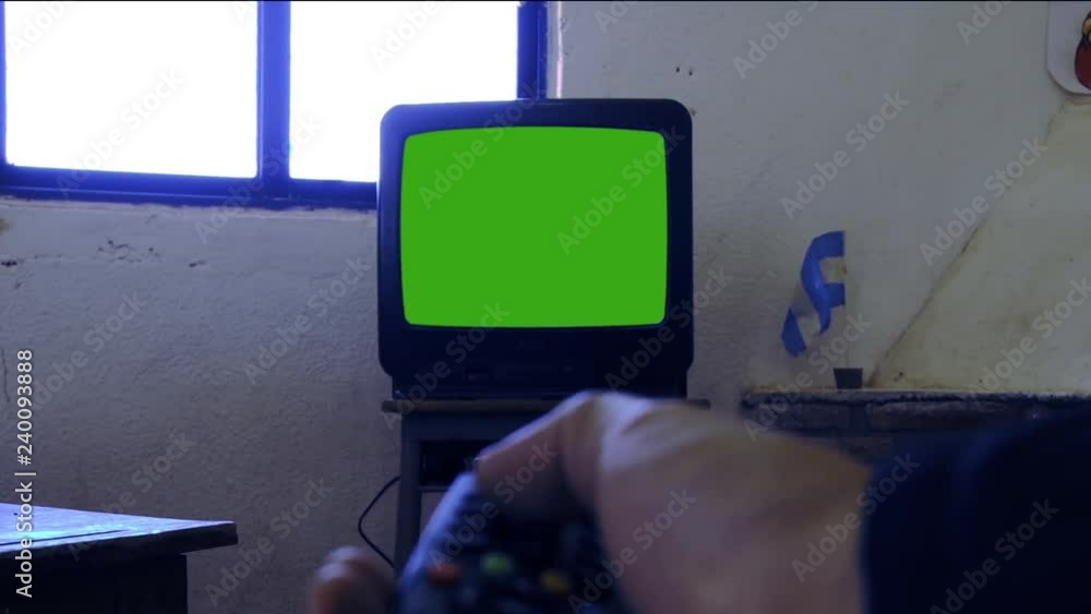 Male Hand Turning On Tv With Green Screen. You can replace green screen ...