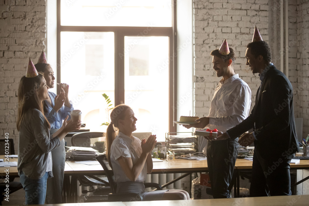 Friendly diverse team staff employees making present surprise giving ...