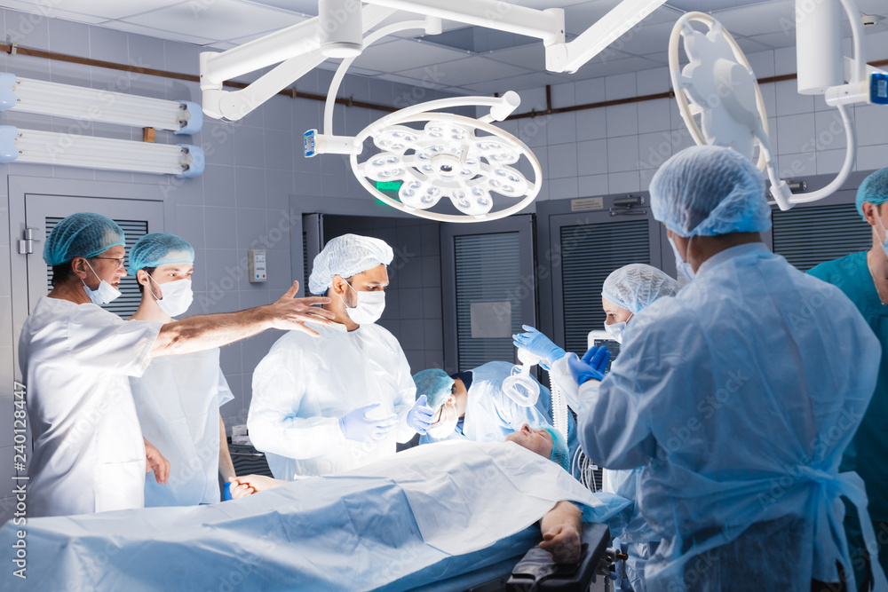 Checking all is fine. Mature male surgeon controlling patient s health ...