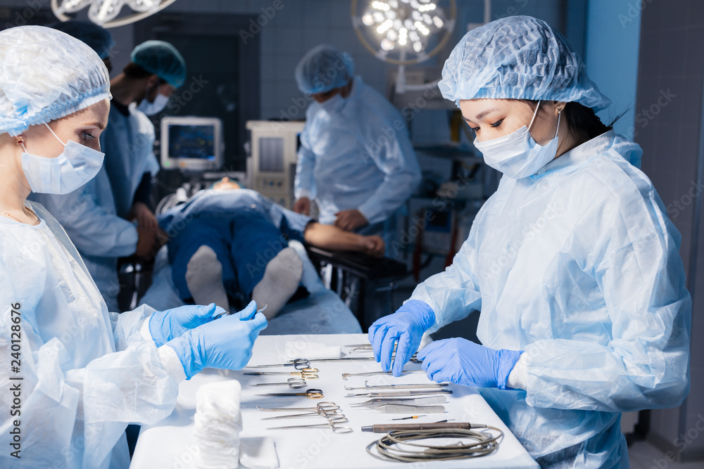 modern hospital operating room with steel sterile medical instruments ...