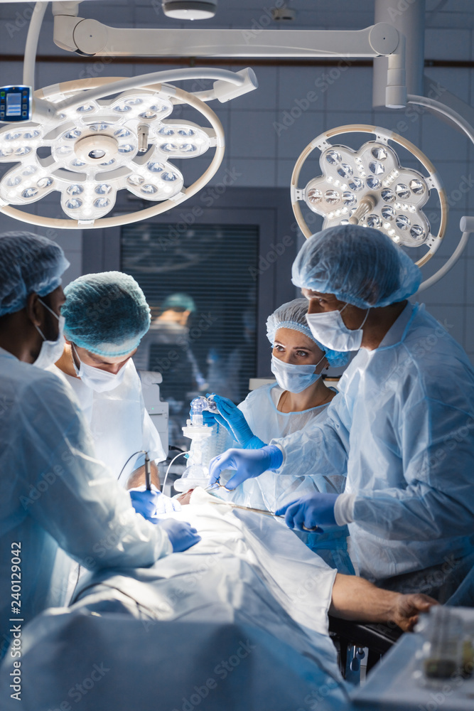 Stitching after a complex and bloody surgery. Modern medical equipment ...