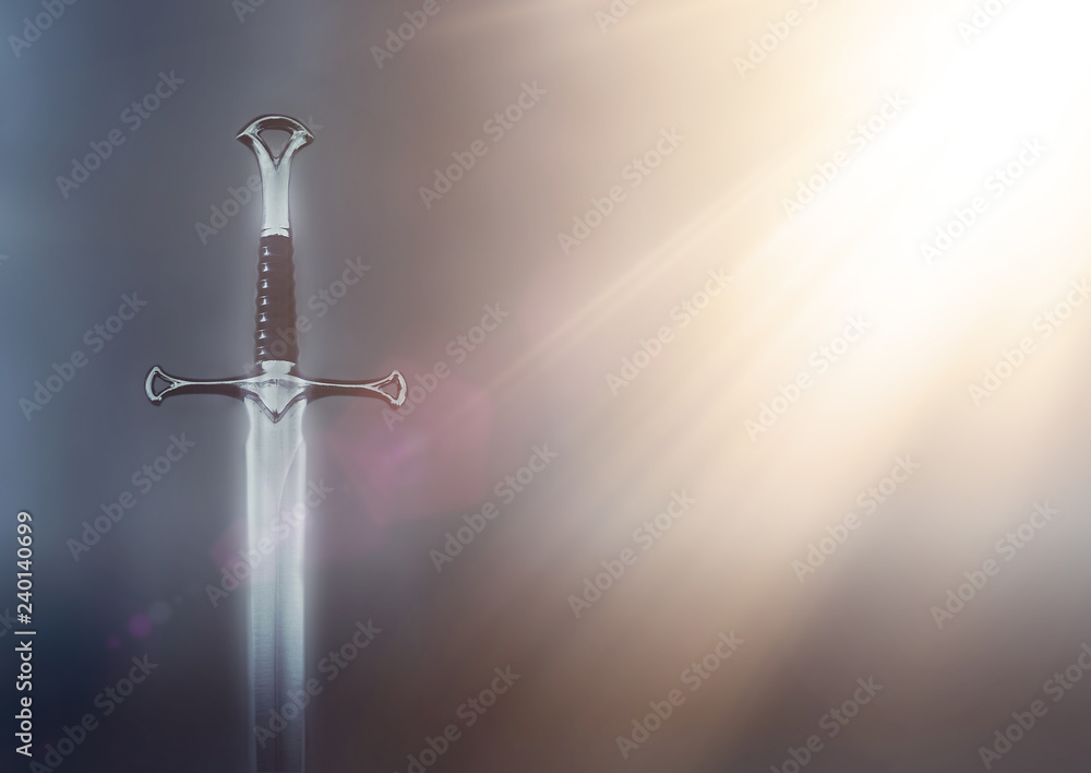 mysterious and magical photo of silver sword over black background with ...