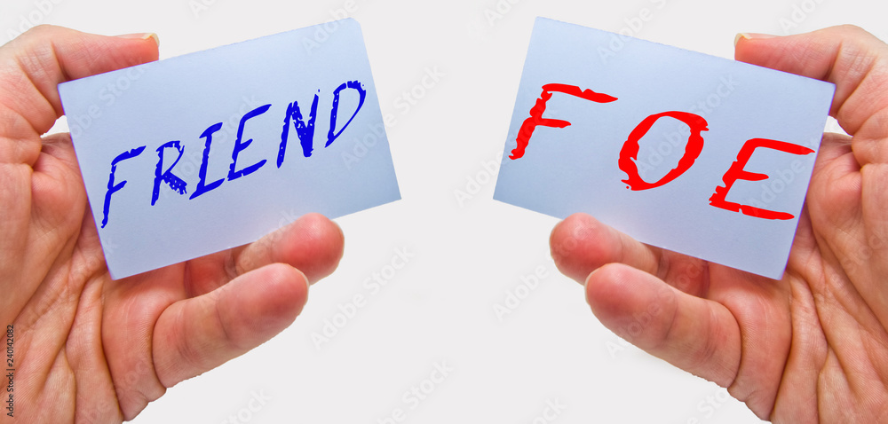 friend or foe signs on cards in man hands with a white background. for ...
