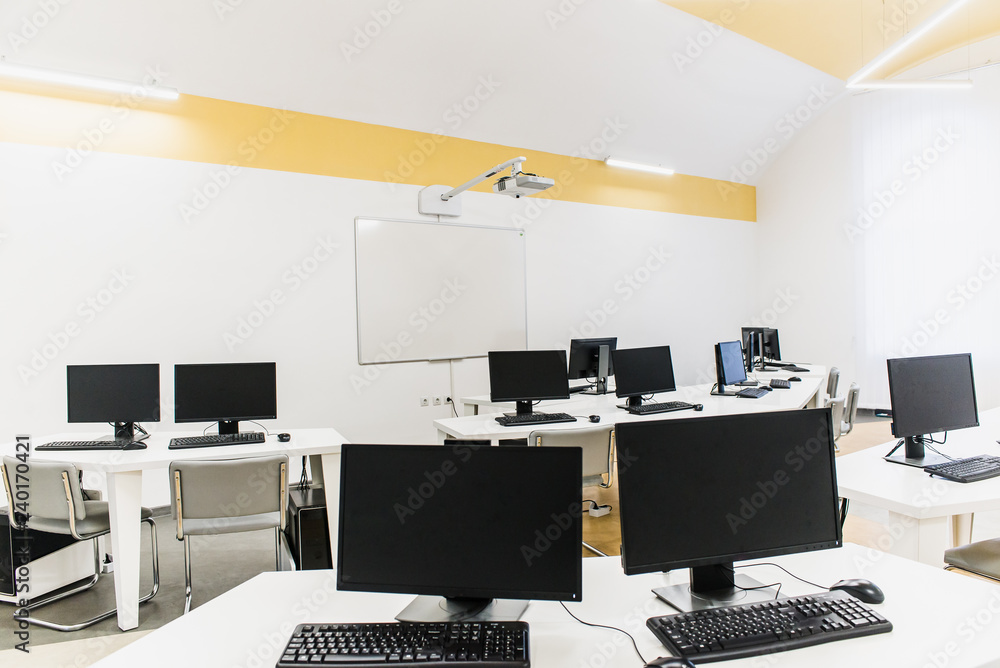 office room with computer tables with keyboard and mouse with a board ...