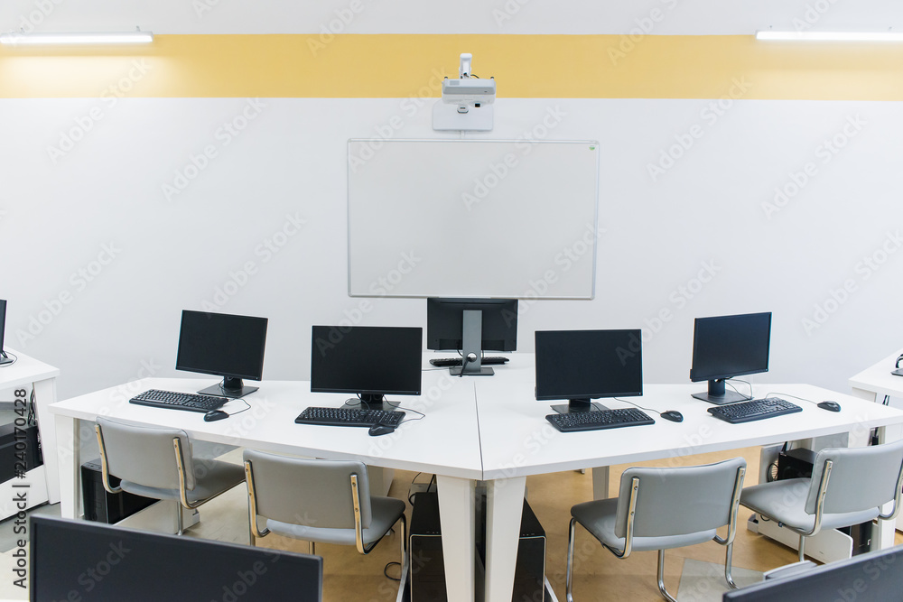 office room with computer tables with keyboard and mouse with a board ...