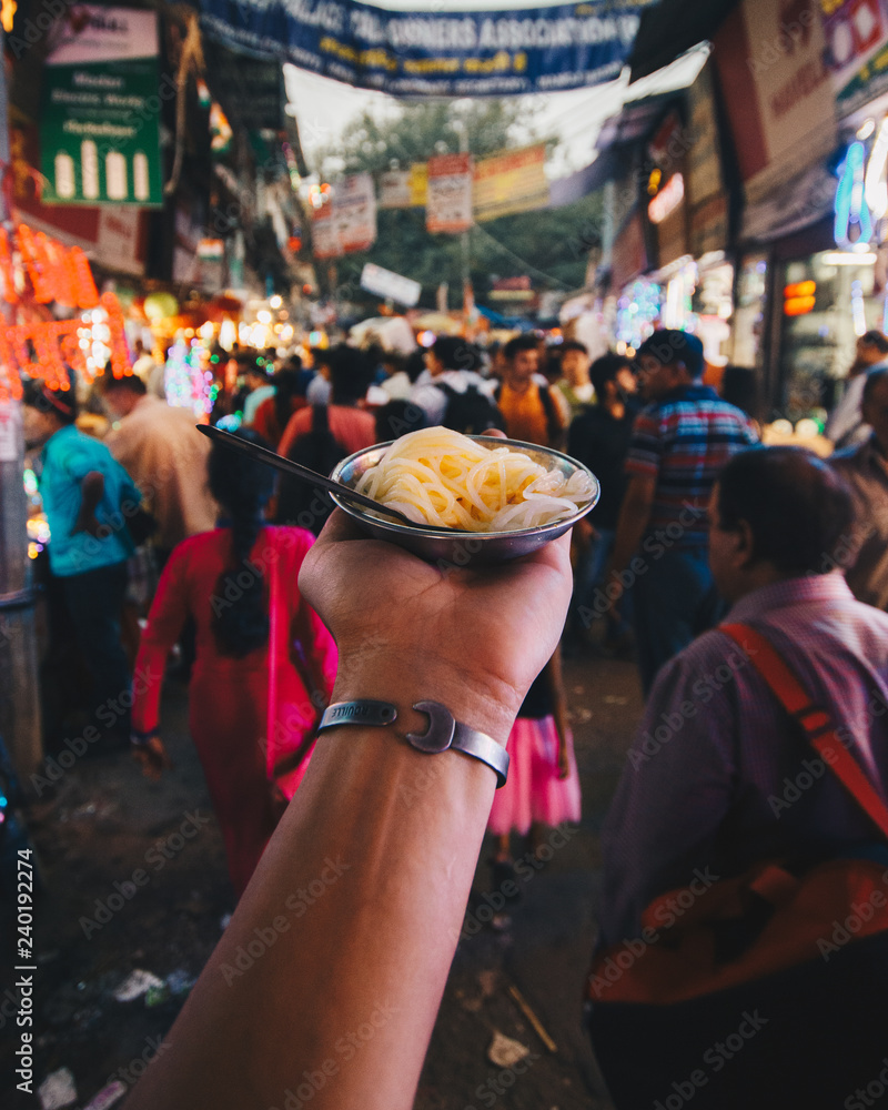 Hand holding indian food Stock Photo | Adobe Stock