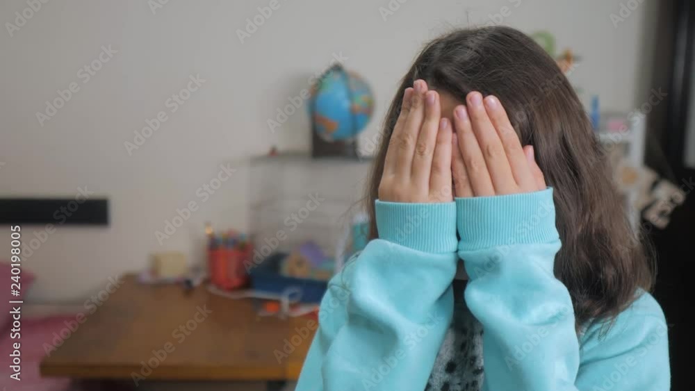 peek a boo. little girl covered her eyes face with her hands hide-and ...