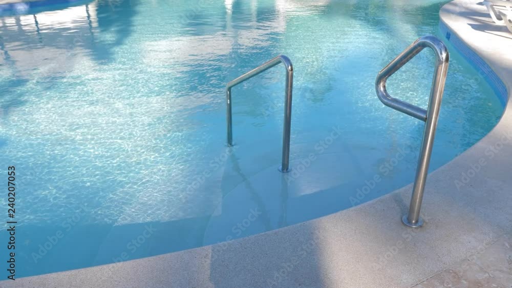 Grab bars ladder in swimming pool at poolside vídeo do Stock | Adobe Stock