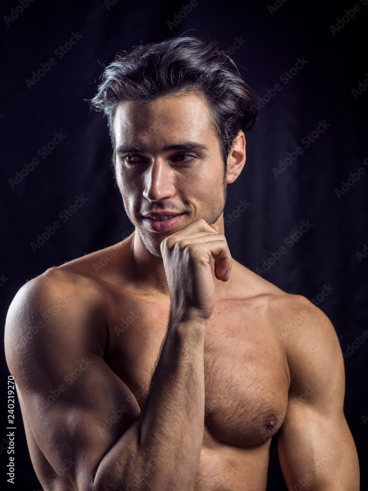 Handsome muscular shirtless young man standing confident, front view ...