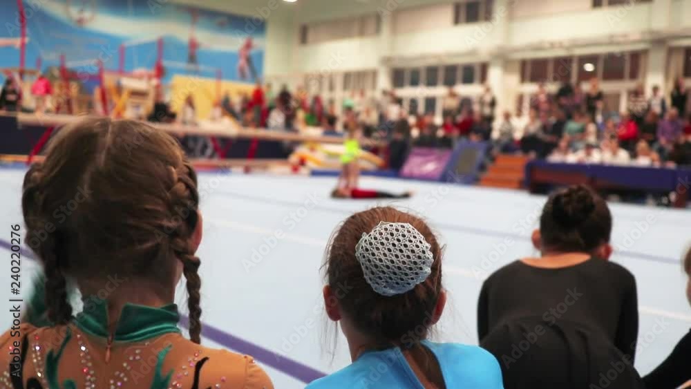 Cheerleading competition. Young athletes in the gym look at the ...