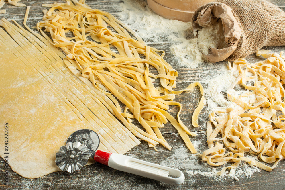 cooking Italian pasta, or noodles. Flat-lay with flour, eggs, slicing ...