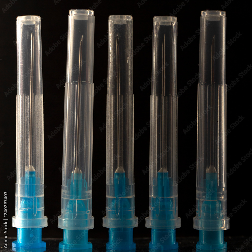 Medical needles with multi-colored heads in plastic covers from a ...