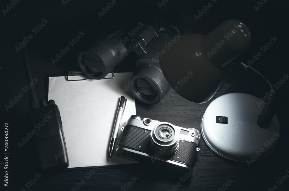 Blank page with copy space, pen, portable radio, binoculars and photo ...
