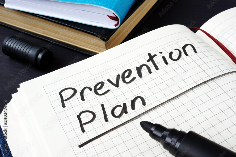 Prevention plan written in a note pad and documents. Stock Photo ...