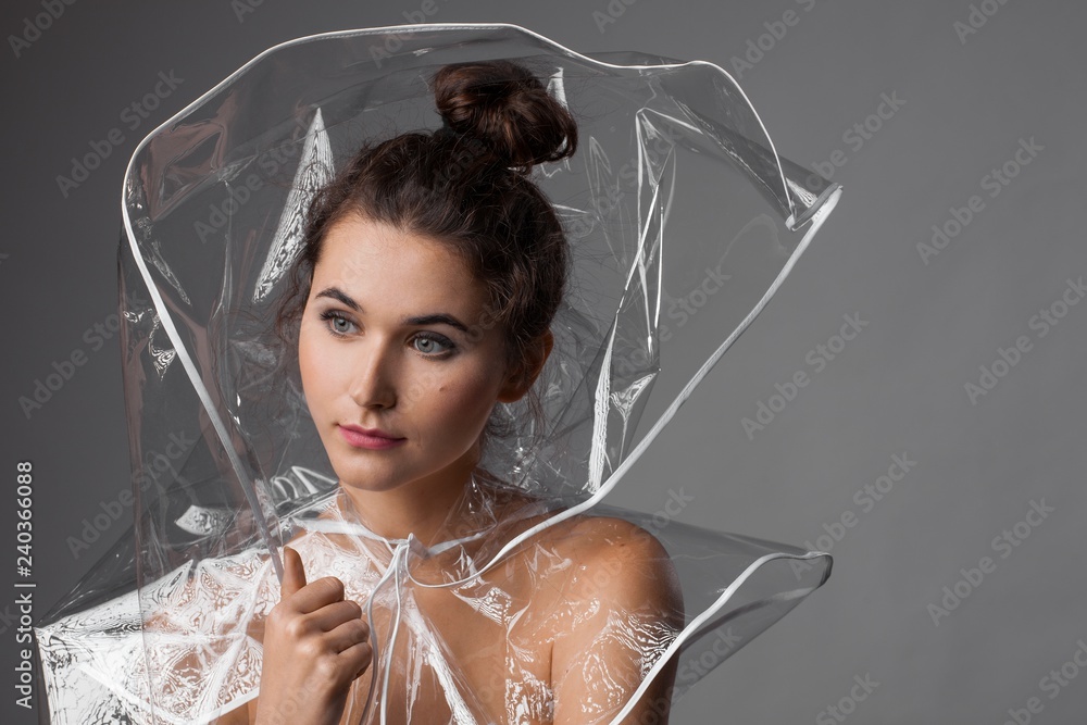 Beautiful woman in a transparent rain coat Stock Photo | Adobe Stock