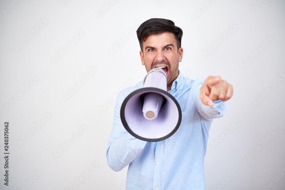 Portrait of young dark haired man announcing into a megaphone and ...