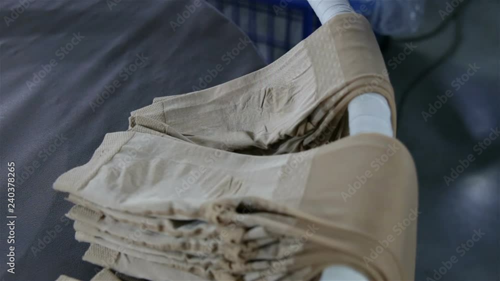 Robotic Arm in Action. Hosiery Manufacturing. Robotic arm working on ...