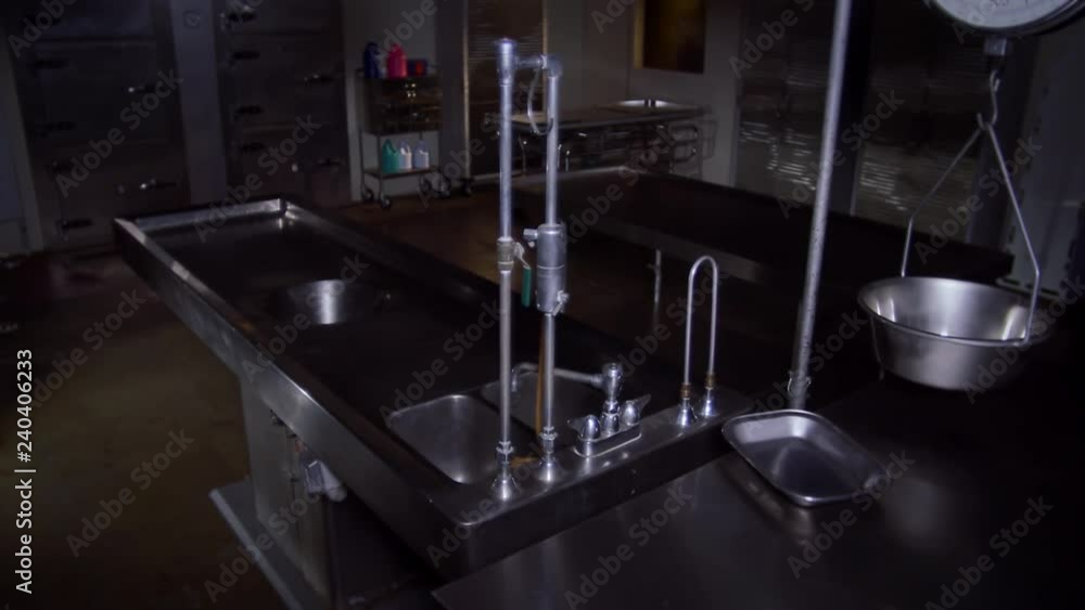 A COLD, EMPTY MORGUE WITH AN AUTOPSY TABLE IN THE FOREGROUND. 4K, 10 ...
