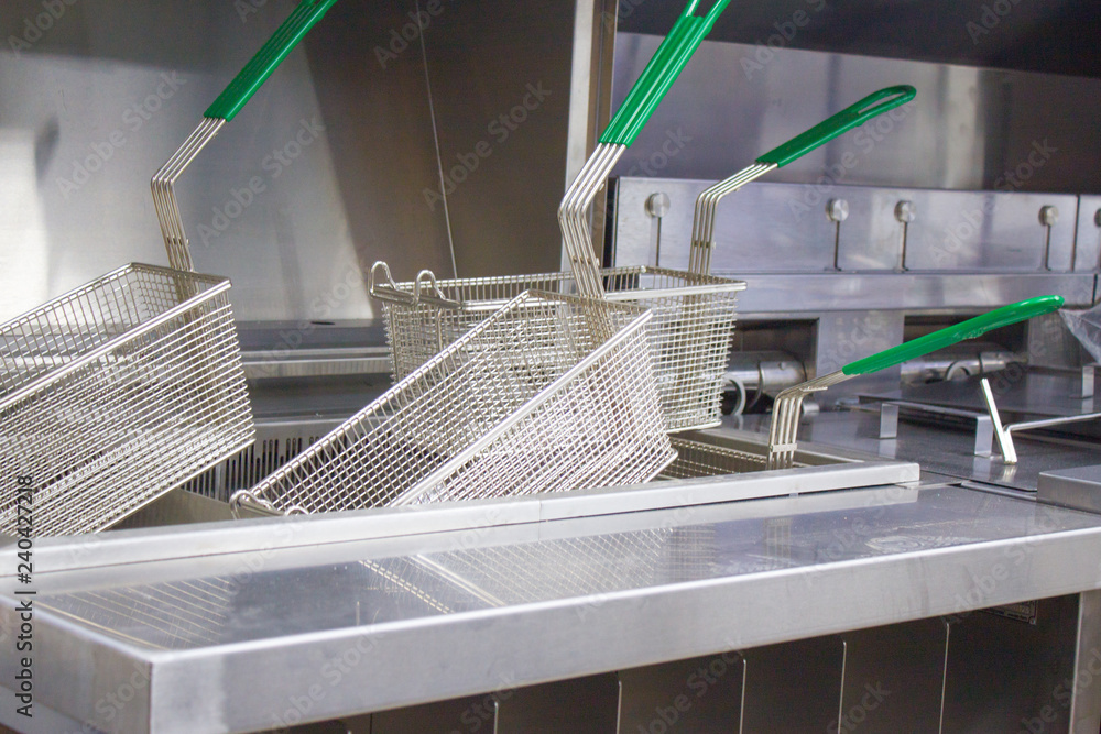 Deep fryer for potatoes and nuggets. New clean empty kitchen. Equipment ...