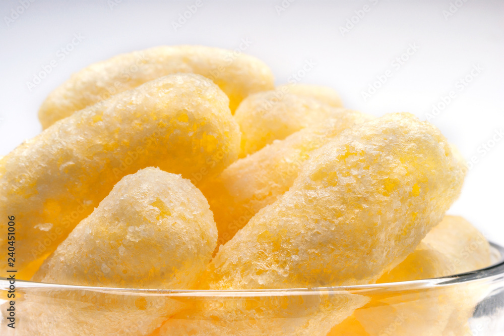 Yellow Corn Puffs in a Glass Bowl. Crunchy Flavored Puffed Snacks ...