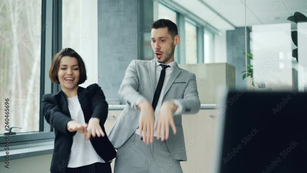 Careless office workers are relaxing at work dancing and laughing ...