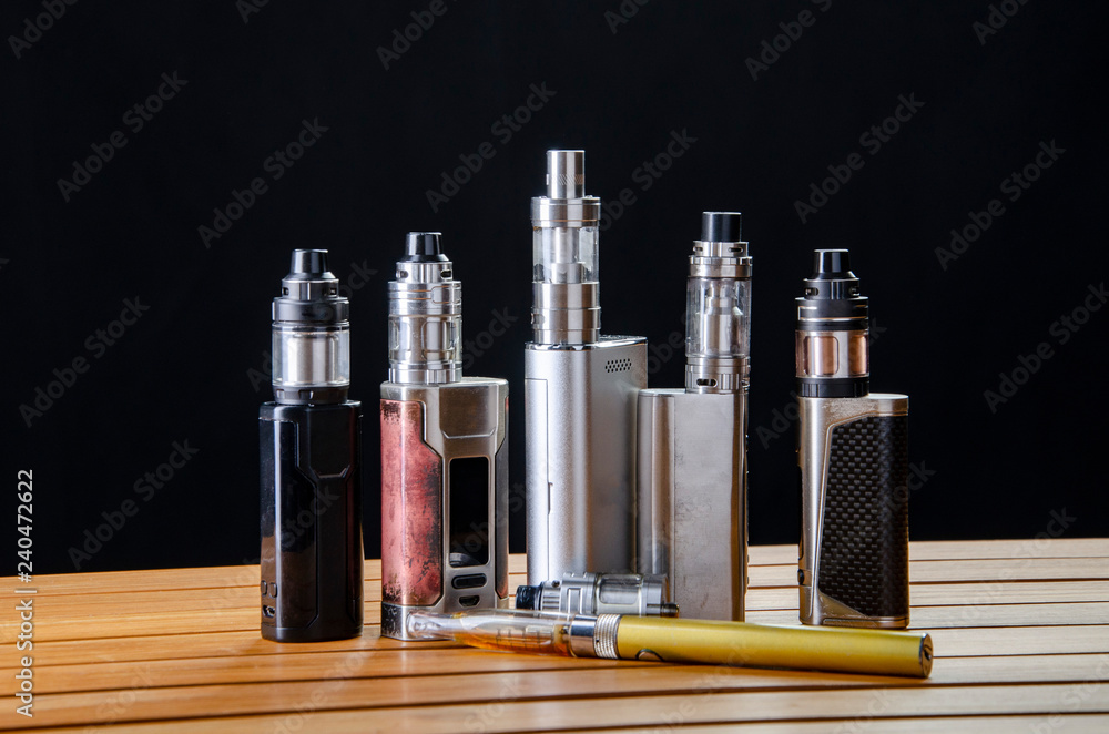 Popular vaping e cig devices mod.electronic cigarette over a black ...