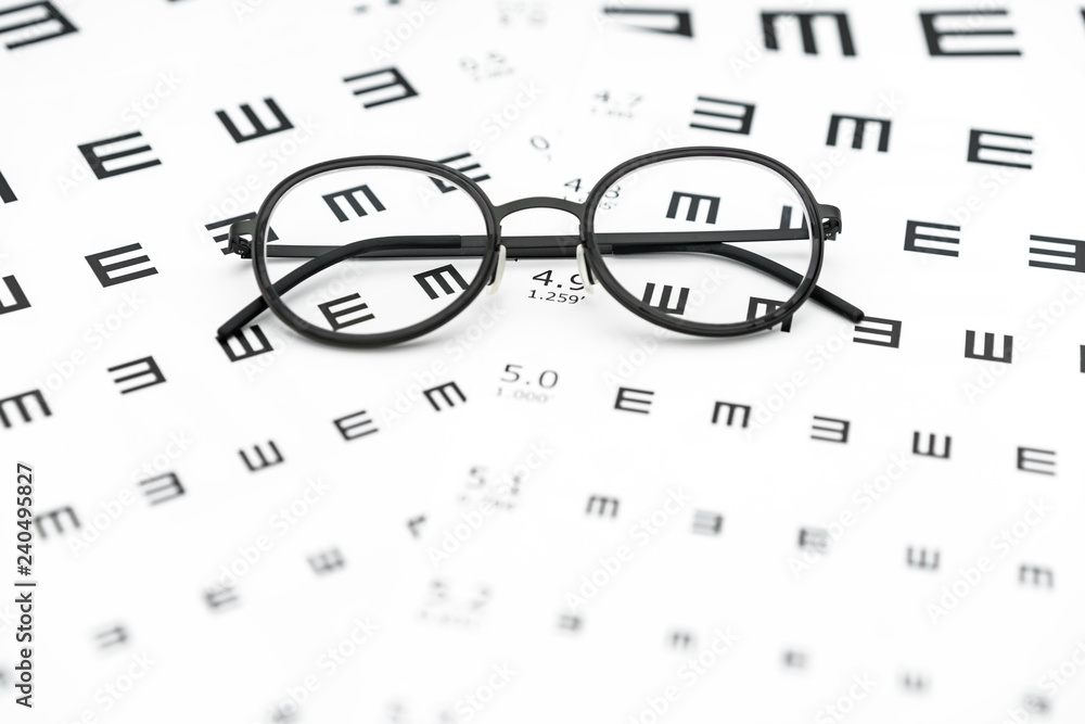 Eyeglasses and visual acuity chart in white background Stock Photo ...