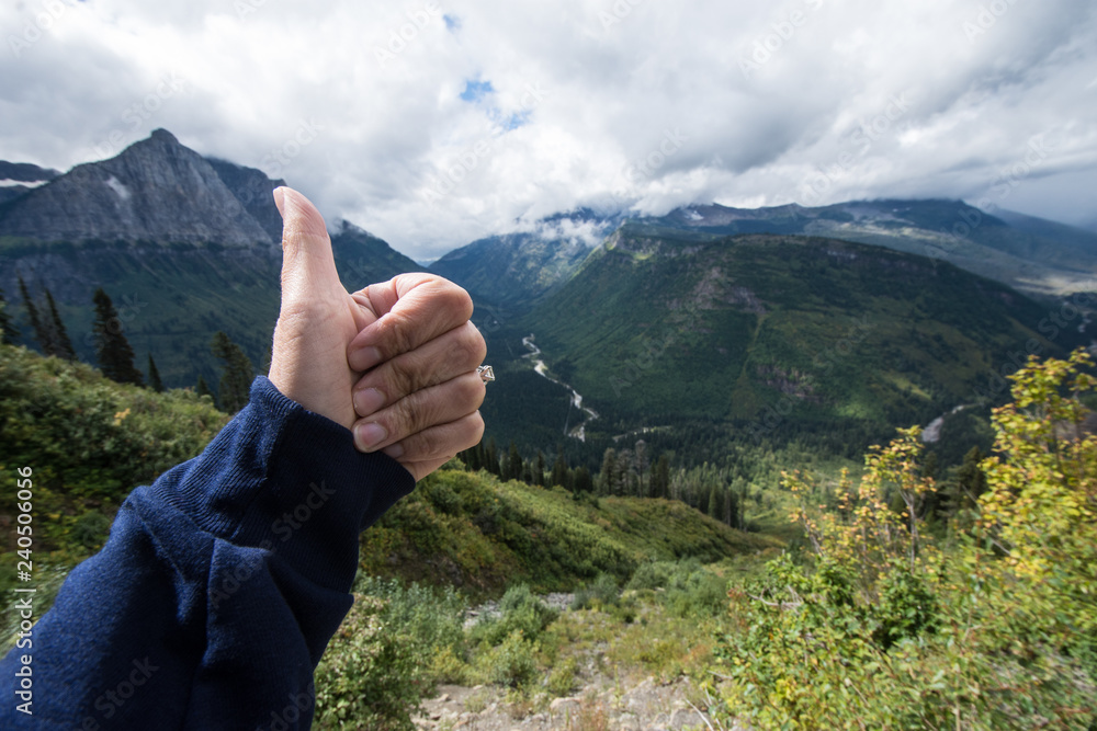 Female hand gives a thumbs up sign to the beautiful scenery along Going ...