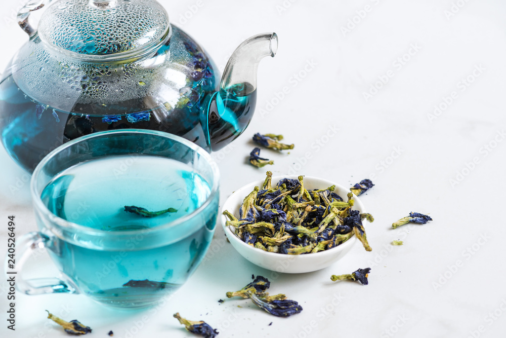 Butterfly pea flower blue tea in a cup with teapot. Healthy detox ...
