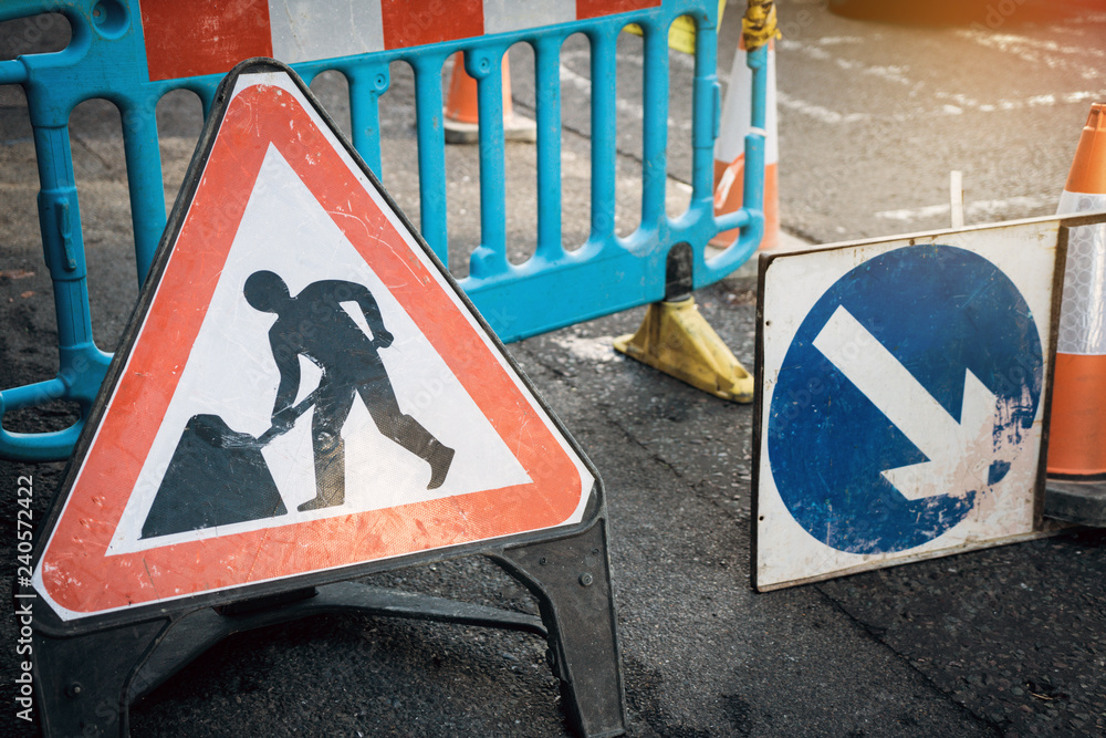 Under construction board sign on the closed road with arrow sign and ...