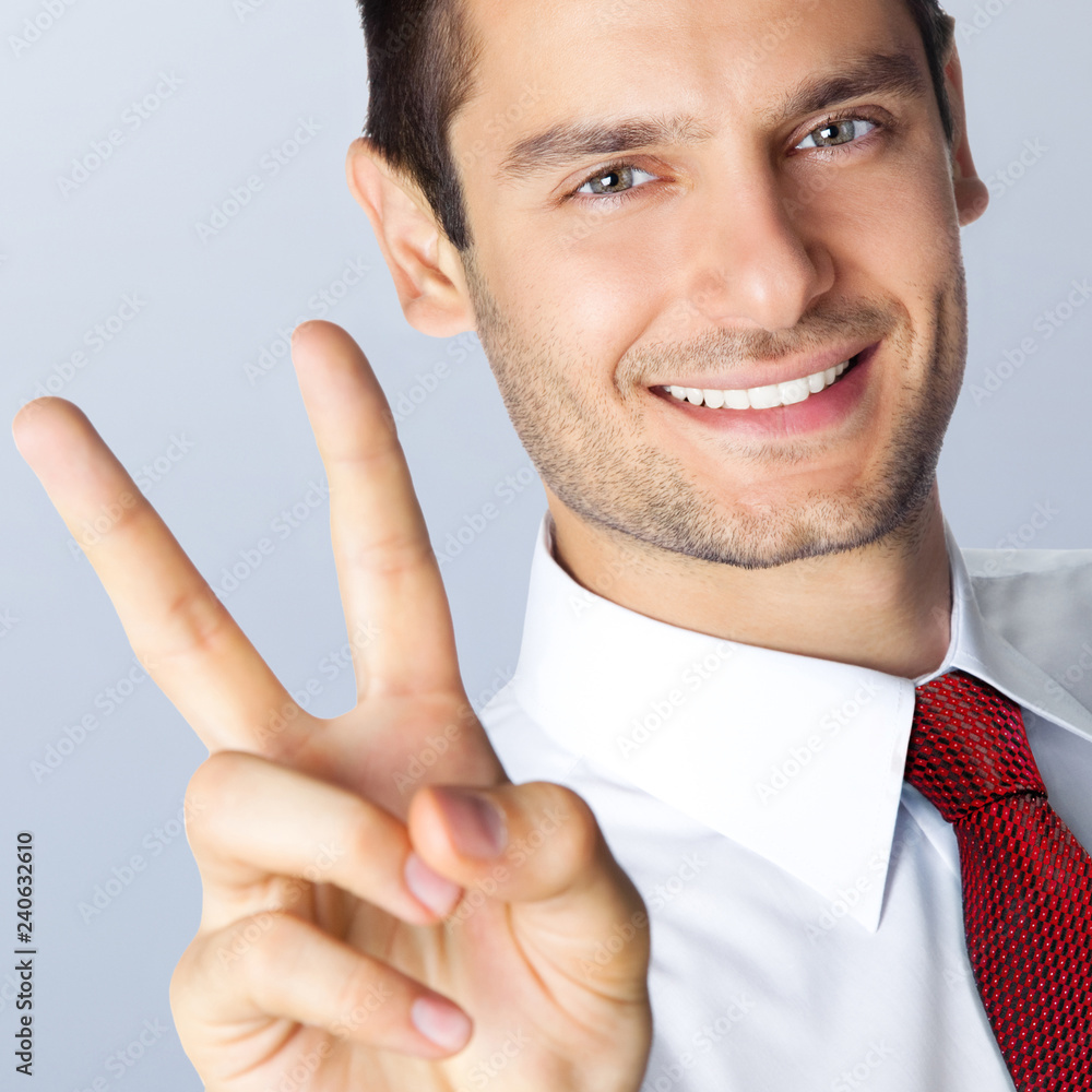 Businessman showing two fingers Stock Photo | Adobe Stock