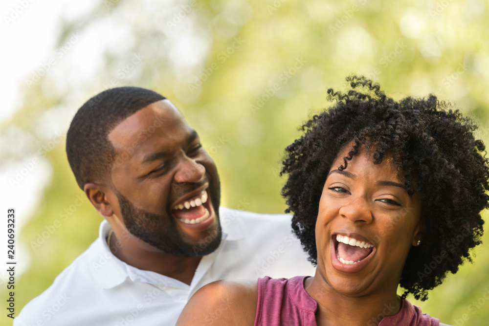Happy African American couple laughing and smiling. Stock Photo | Adobe ...