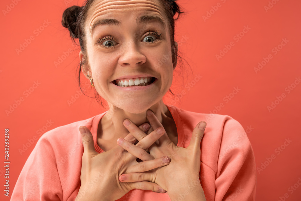 Delight. Beautiful female half-length front portrait isolated on coral ...