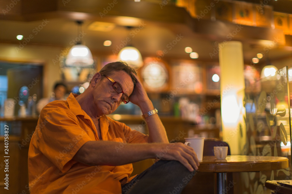 Man In A Cafe In A Ill humored Mood Contemplative Staring And Wearing A