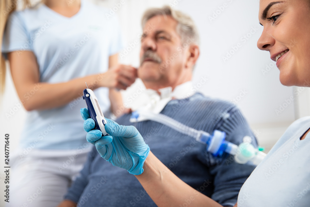 Two nurses care for an intensely awake patient in the hospital nursing ...