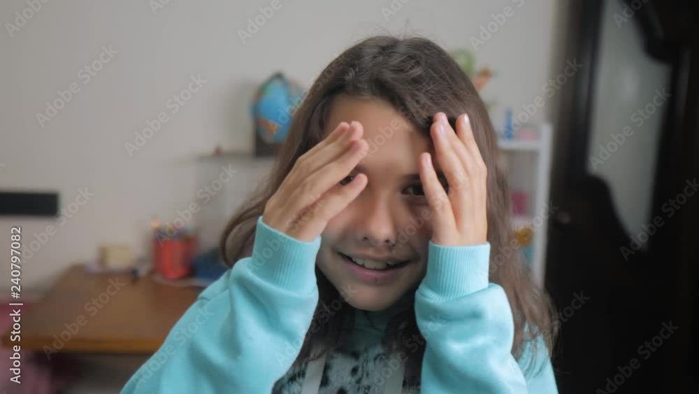 peek a boo. little girl covered her eyes face with her hands hide-and ...